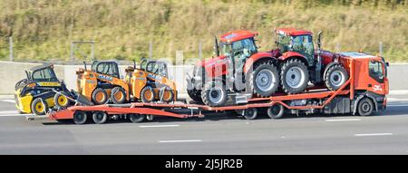 Side view of a load of new agriculture farm tractors on adjustable low ...