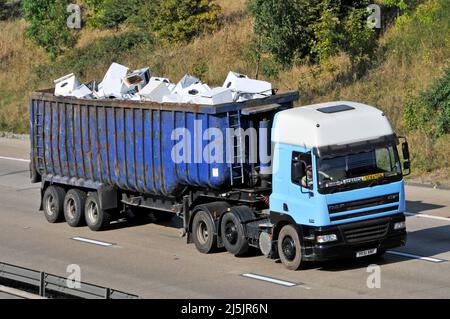 Front & side view of tow trailer & unmarked hgv flatbed lorry truck ...