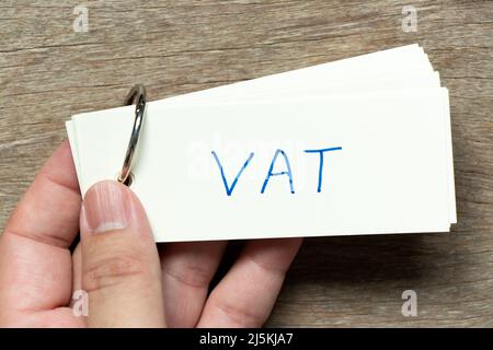 Flash card with handwriting word VAT (abbreviation of value added tax ...