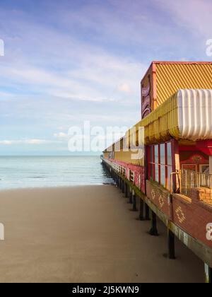 A fun fair complex on a pier, extending out into the sea at Frinton ...
