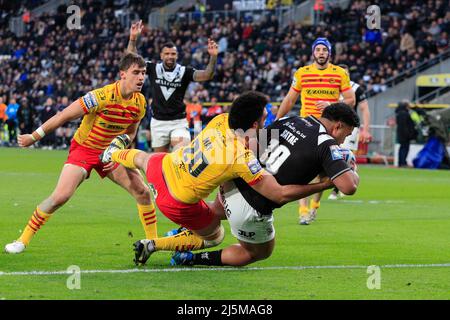 Chris Satae #10 of Hull FC breaks through the Leeds defence to race to ...