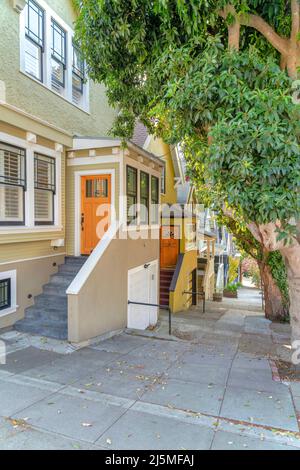 Houses on a slope downhill path at San Francisco, California. There are ...