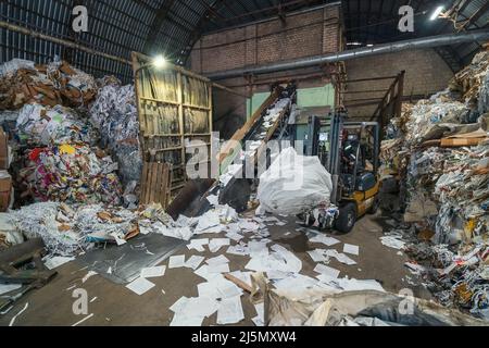 Waste paper sorting and filing for processing at paper recycling plant ...