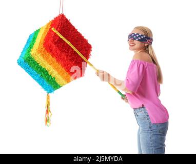 Young woman with blindfold breaking Mexican pinata on beige background ...