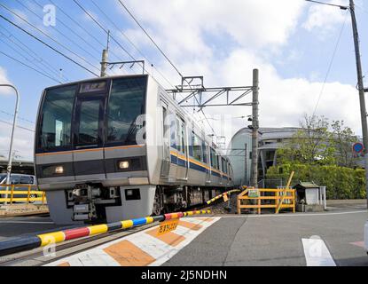 A train passes near the site of the derailment accident in Amagasaki City, Hyogo Prefecture on ...