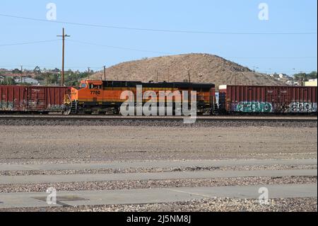 BNSF 7780 BNSF Railway GE ES44DC locomotive passing through Barstow station with a freight train ...