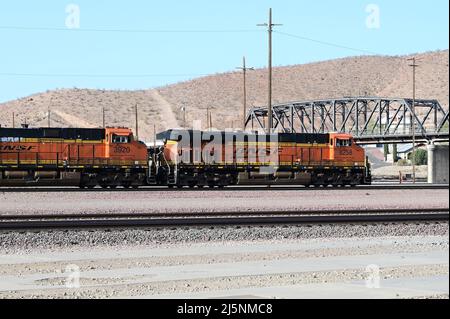 BNSF 7780 BNSF Railway GE ES44DC locomotive passing through Barstow station with a freight train ...