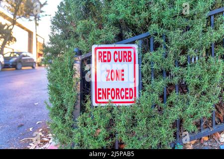 Red curb zone enforced signage beside the road in San Francisco ...