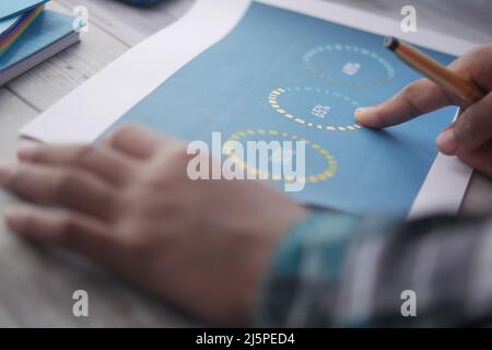 man hand with pen analyzing bar chart on paper Stock Photo - Alamy