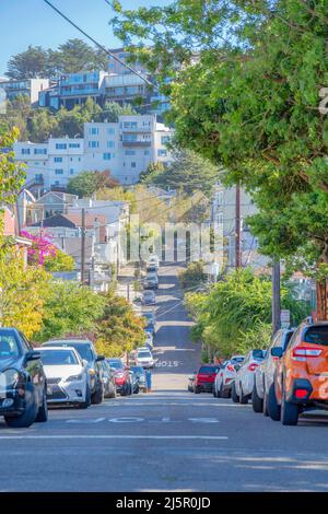 Sloped concrete road with parked vehicles on both sides at San ...