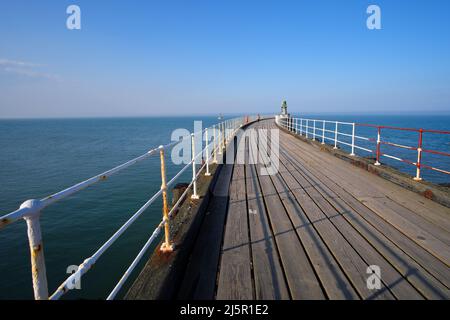 The boardwalk to the lighthouse on Whitby's outer harbour in Whitby ...