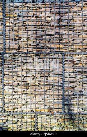 Gabions, stones in wire cages are a modern design option in gardens and ...