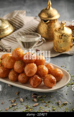 luqaimat or lokma. Freshly fried Lokma (luqma - arabic) piled high a ...