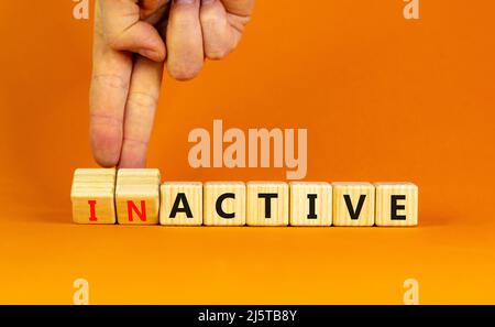 Active or inactive symbol. Businessman turns wooden cubes and changes ...