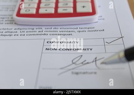 An auditor giving signature at audit report and finalizing the result ...
