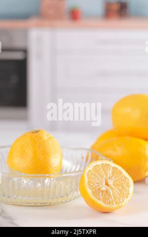 Lemon Being Juiced on a Marble Kitchen Counter Stock Photo - Alamy