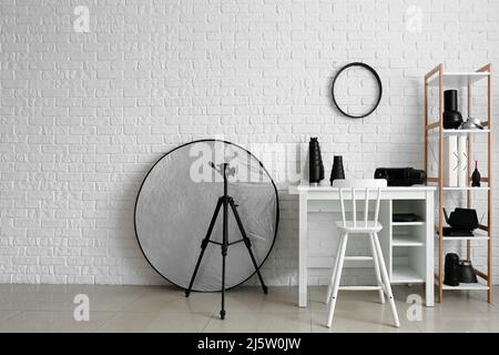 Workplace and shelf unit with different equipment of photographer in ...