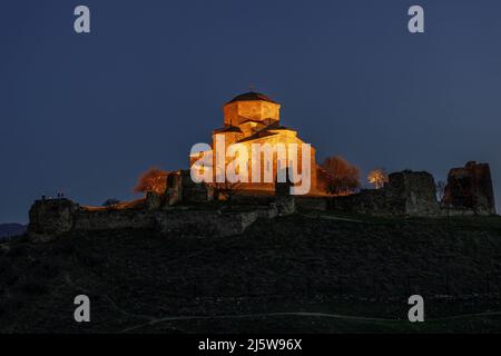 Illuminated Jvari Monastery on the top of the hill at night. Mtskheta ...