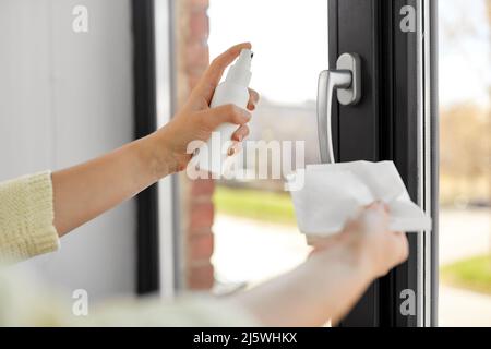 woman cleaning window handle with sanitizer tissue Stock Photo - Alamy