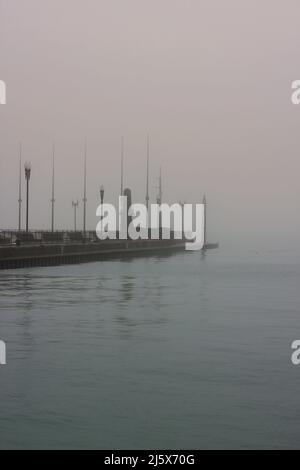 Waterfront pier in very heavy fog on the shoreline Stock Photo - Alamy