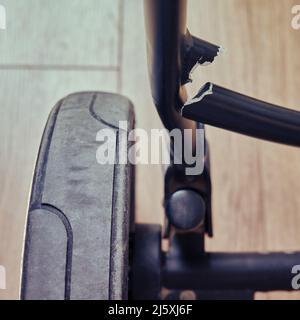 Broken chassis of a baby stroller, damage to the crossbar of the metal ...