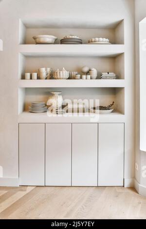 Cups arranged on a wooden shelf in a cafe setting Stock Photo - Alamy