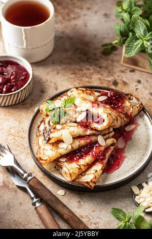 Close up of crepes with jam on plate, breakfast Stock Photo - Alamy