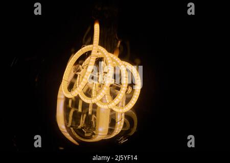long tube-shaped Edison lamp, bulb, black background Stock Photo - Alamy
