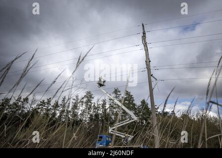 Workers repair power lines Tuesday, March 3, 2020, after a tornado ...