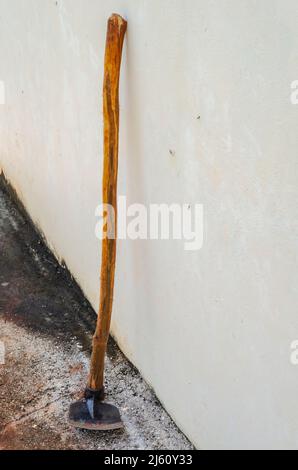Farm tools leaning against a wall in a barn Stock Photo - Alamy
