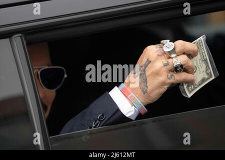 A fan handed Actor Johnny Depp money as he arrives for his anti ...