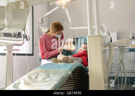 The mother and her daughter wearing protective medical masks sitting in ...