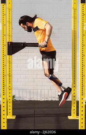 An amputee man is exercising on parallel bars at The National ...