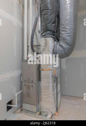 HVAC system inside a utility closet room with white markings on the ...