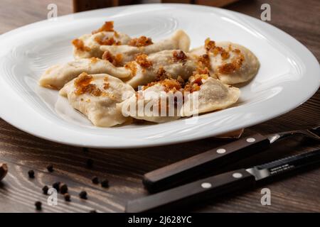 Traditional ukrainian dish vareniki served in a bowl with sour cream ...
