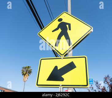yellow road sign for pedestrian directing this way Stock Photo - Alamy