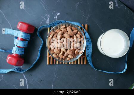 dumbbell, almond nut and milk on black background Stock Photo - Alamy