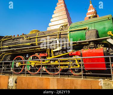 vintage steam rail engine with temple and blue sky background at day ...