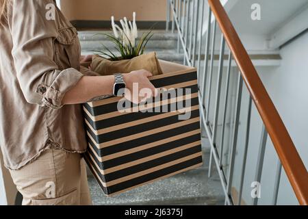 Horizontal medium shot of unrecognizable woman wearing mask sitting in ...