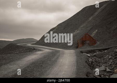 Derelict Corrugated Iron House, half buried in a large shale pile near ...