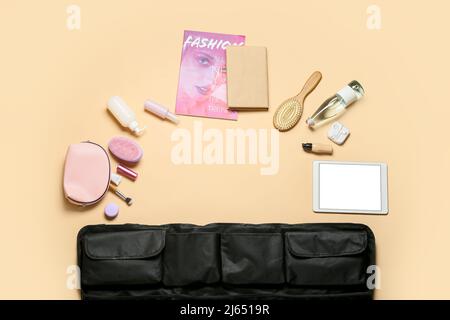 Frame made of travel organizer with different things on color ...