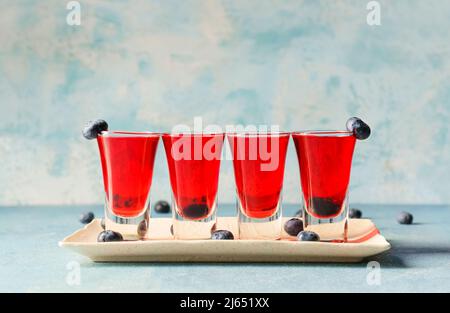 Plate with shot cocktails on color background, closeup Stock Photo - Alamy