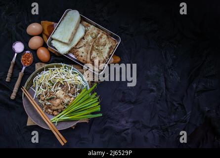 Stir-fried soft turnip cake or Fried radish cake (chai tow kway) with ...