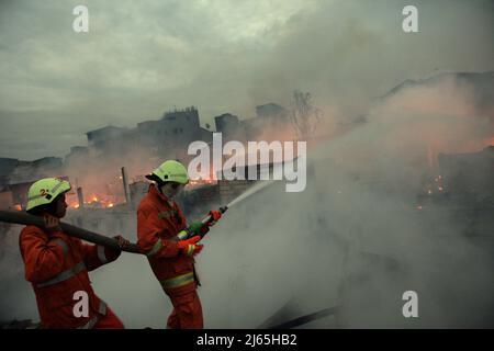 Firefighters performing the cooling phase after a fire accident burned ...