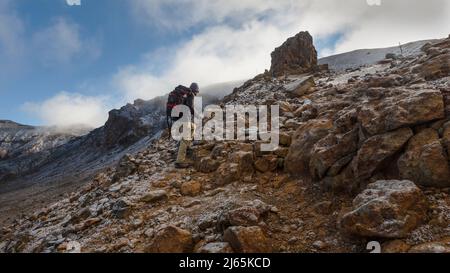 Hiking the steep scree terrain to the Red Crater on Tongariro Alpine ...
