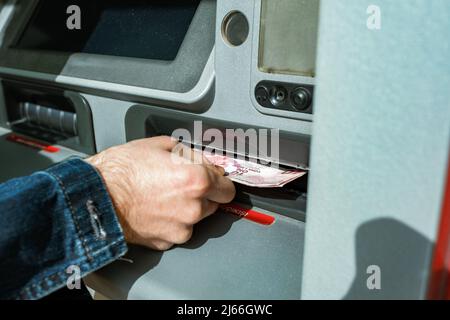 Hand taking (withdraw) money from ATM Stock Photo - Alamy
