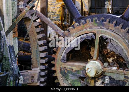 Giant rusted cog wheels rest beside an old water wheel in Abbeydale ...
