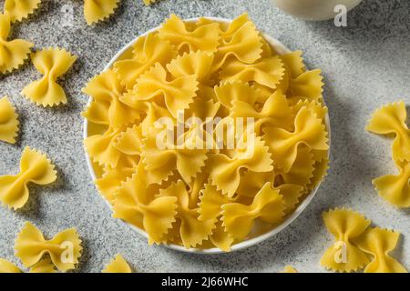 Raw dry farfalle pasta ready for cooking Stock Photo - Alamy