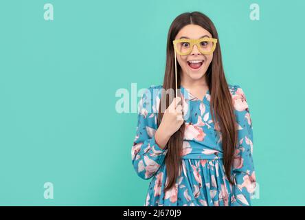 Make it fun. Funny girl hold prop glasses. Happy kid smile having fun ...