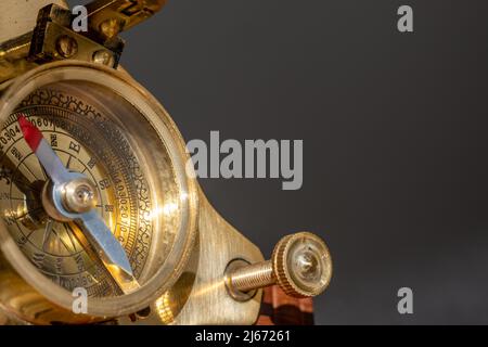 Detail of an antique maritime bronze solar compass in black and white ...